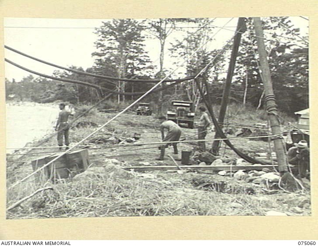 LAE, NEW GUINEA. 1944-08-08. TRUCKS PULLING THE "FLYING FOX" CARRIAGE ...