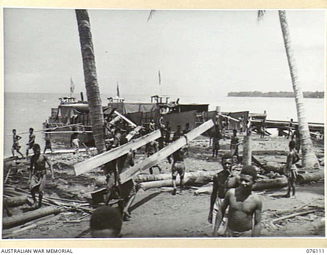 KARKAR ISLAND, NEW GUINEA. 1944-09-20. NATIVES WORKING UNDER THE ...