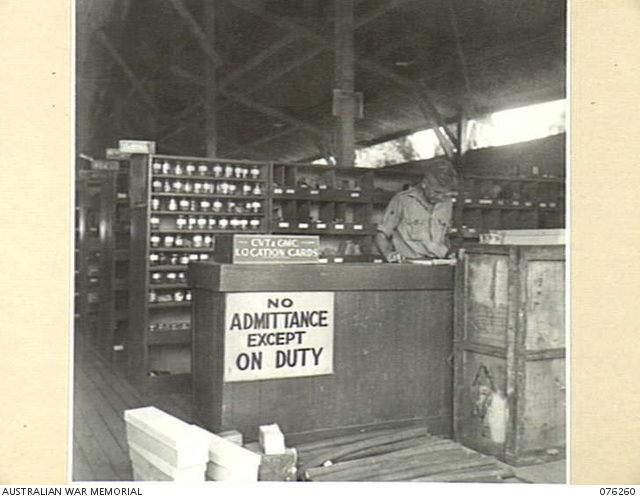 LAE, NEW GUINEA. 1944-09-27. A STOREMAN AT WORK IN ONE OF THE SPARE ...