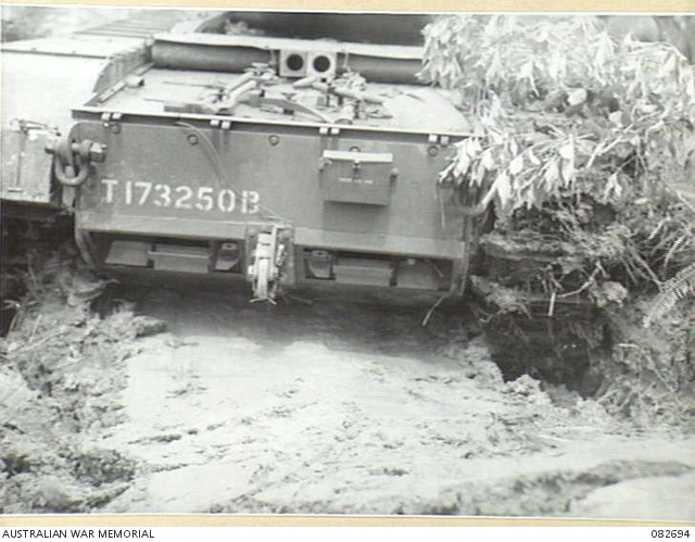 MADANG, NEW GUINEA. 1944-10-12. A CHURCHILL V TANK NEGOTIATING THICK MUD WHERE TWO MATILDA TANKS ...