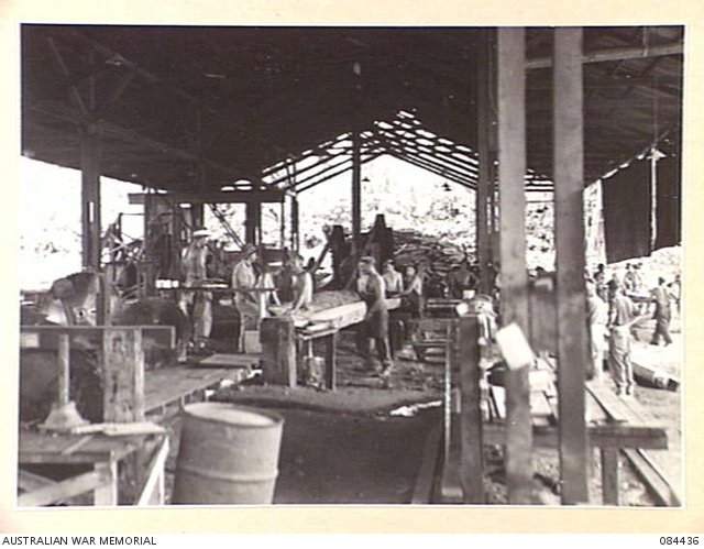 LAE, NEW GUINEA. 1944-12-21. THE INTERIOR OF THE BUSU MILL OPERATED BY ...