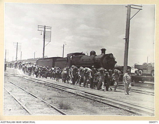 CLAPHAM JUNCTION, QLD. 1944-12-08. A DRAFT FROM MELBOURNE BEING MARCHED ...