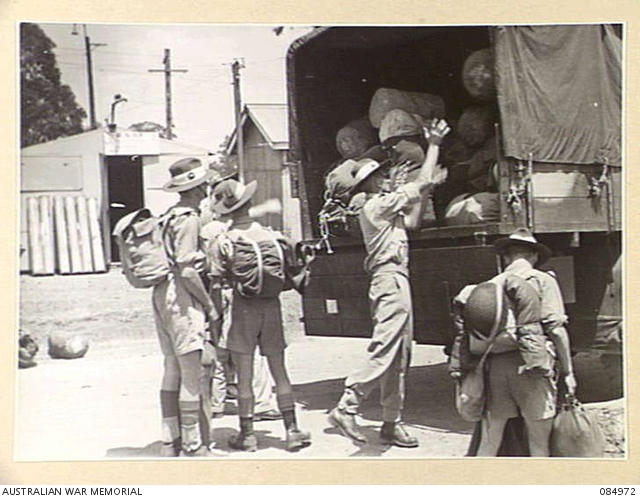 CLAPHAM JUNCTION, QLD. 1944-12-08. TROOPS BEING RELIEVED OF THE WEIGHT ...