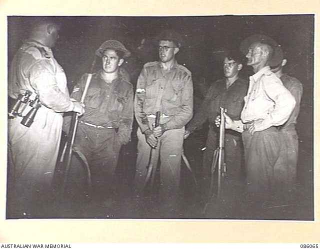 CABOOLTURE AREA, QLD. 1945-01-31. "RAIDERS" AT THE LEFT, DISCUSS WITH ...