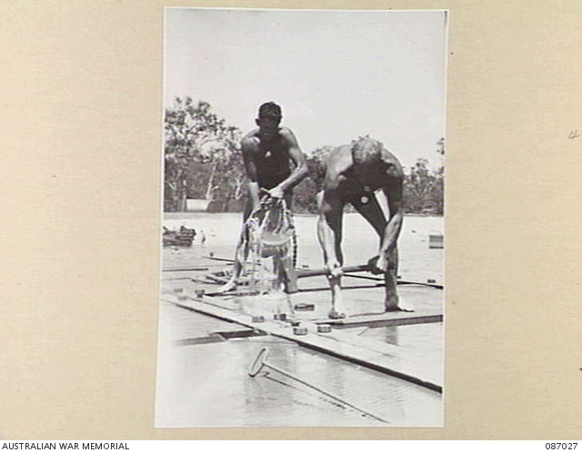 CAIRNS AREA, QLD. SAPPER S D BROWN, (1), SLOSHES WATER OVER THE HOT ...