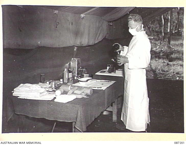 KAIRI, QLD. 1945-02-23. PRIVATE F J SWEENEY, 2/4 FIELD AMBULANCE POURS ...