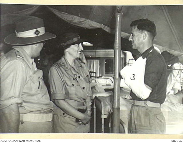 ROCKY CREEK, QUEENSLAND. 1945-03-21. LADY WAKEHURST, (2), SPEAKING WITH ...