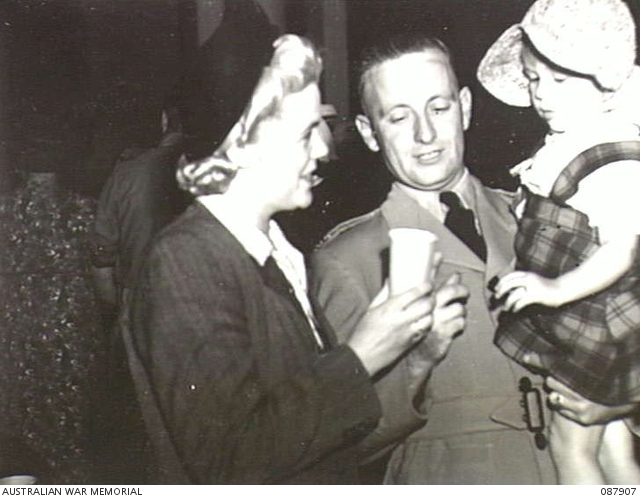 SYDNEY, NSW. 1945-03-29. FLYING OFFICER M. ROBINSON, WITH MRS M ...