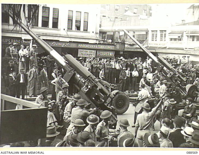 BRISBANE, QUEENSLAND. 1945-04-16. A GUN CREW OPERATING 3.7 INCH GUNS ...