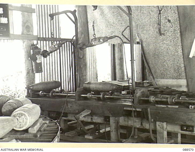 HELIDON, QUEENSLAND. 1945-04-03. A MACHINE AT 11 FIELD AMMUNITION DEPOT ...