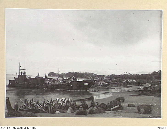 AITAPE, NEW GUINEA. 1945-04-19. SUPPLIES BEING UNLOADED FROM BARGES AT ...