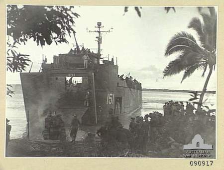 SADAU ISLAND, BORNEO. 1945-04-30. EQUIPMENT COMING OFF LANDING CRAFT ...