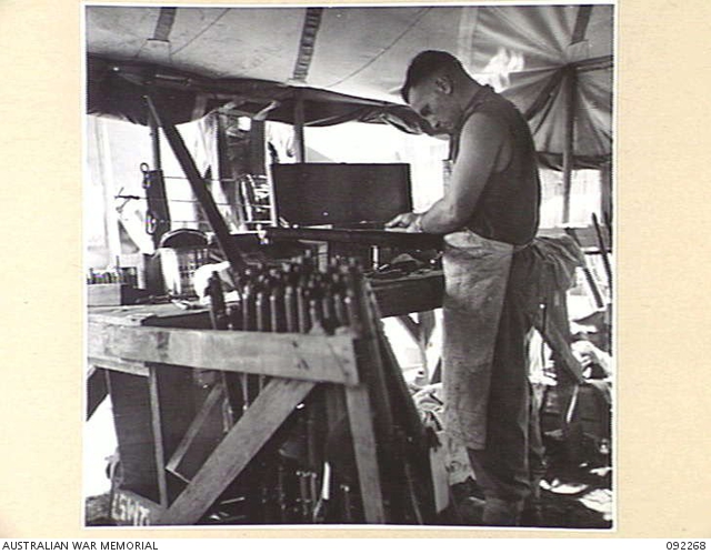 MOROTAI, 1945-05-18. CRAFTSMAN K.A. ELLIS, AT WORK IN THE ARMOURERS ...