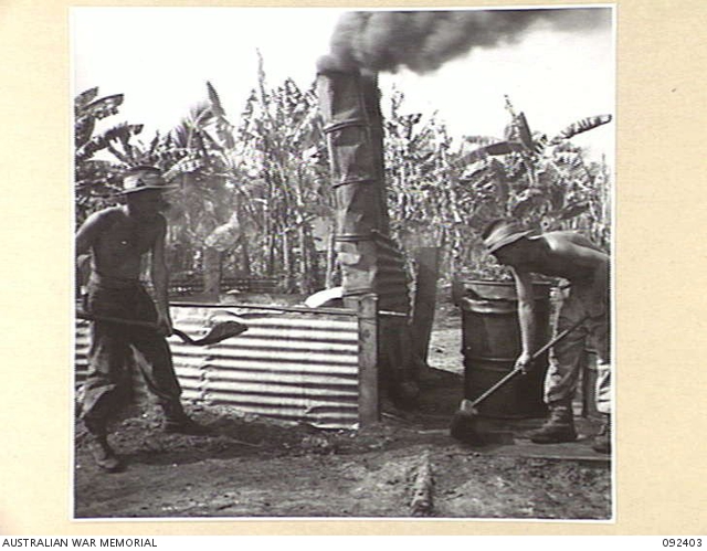 MOROTAI, 1945-05-19. MEMBERS OF THE HYGIENE SQUAD TENDING THE REFUSE ...