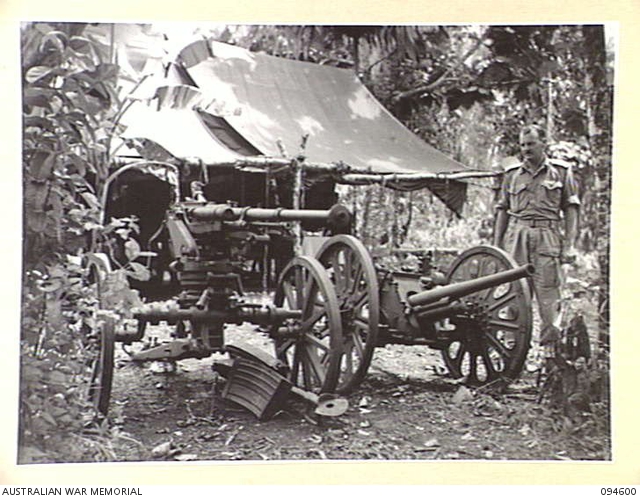 NANTAMBU, NEW BRITAIN, 1945-07-26. MAJOR R.L. CURTIS BESIDE CAPTURED ...