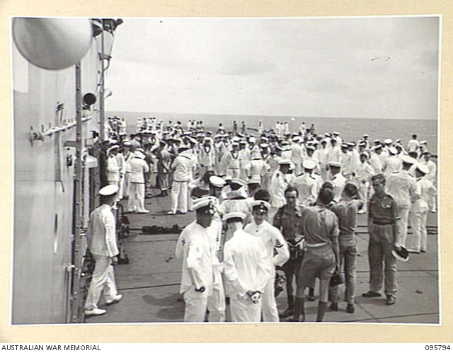 AT SEA OFF RABAUL, NEW BRITAIN. 1945-09-06. NAVAL RATINGS WAITING TO ...