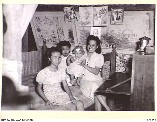 RATONGOR, NEW BRITAIN. 1945-09-13. THE PING FAMILY IN A TIN HUMPY, THE ...
