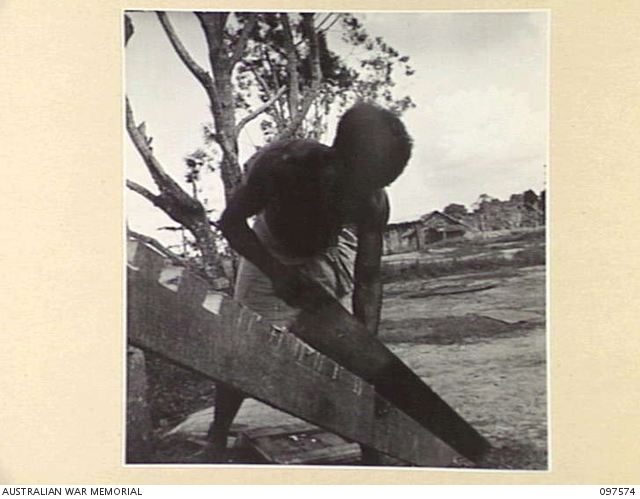 MAPRIK, NEW GUINEA. 1945-10-03. A NATIVE AT WORK AT AUSTRALIAN NEW ...