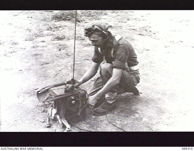 RABAUL, NEW BRITAIN, 1945-12-06. A SIGNALLER DEMONSTRATING WITH A KEY ...