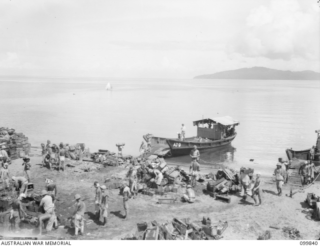 RABAUL, NEW BRITAIN, 19 FEBRUARY 1946. JAPANESE TROOPS LOADING BARGES ...