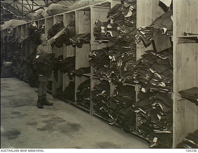 Tel El Kebir, Egypt. 1941-11. Shelves of uniforms in the Details ...