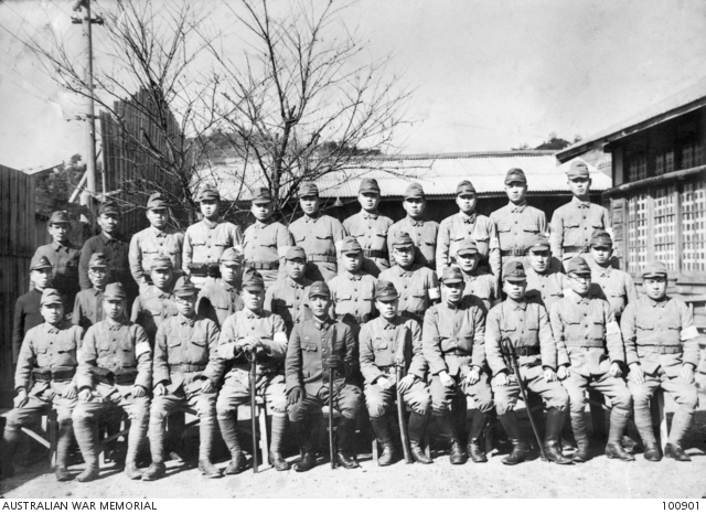 Group portrait of Japanese personnel on the staff of Prisoner of War ...