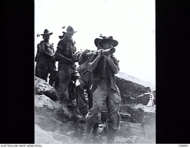 Members of 13th Battery, 2/7th Field Regiment bringing up sections of a ...