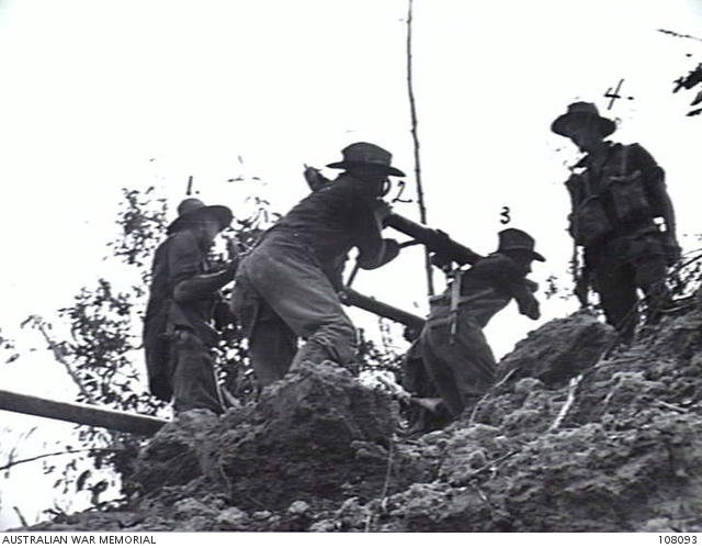 TARAKAN ISLAND. 1945-05-23. MEMBERS OF 2/7TH FIELD REGIMENT CARRYING ...