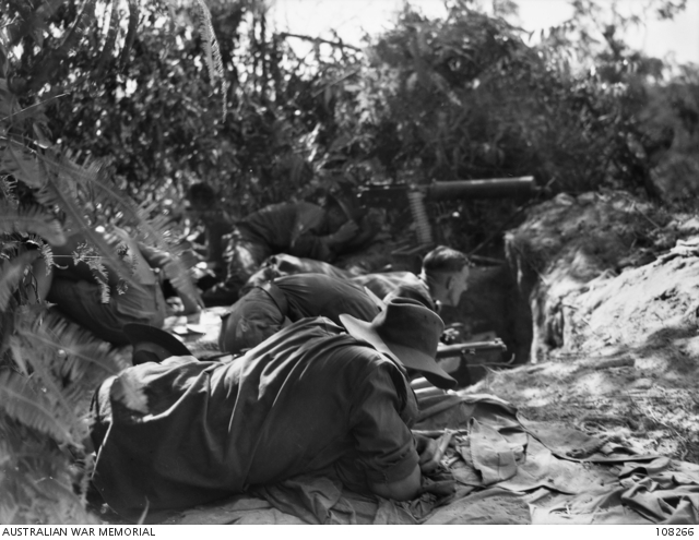 TARAKAN ISLAND, 1945-05-26. TROOPS TAKING SHELTER FROM FLYING SHRAPNEL ...