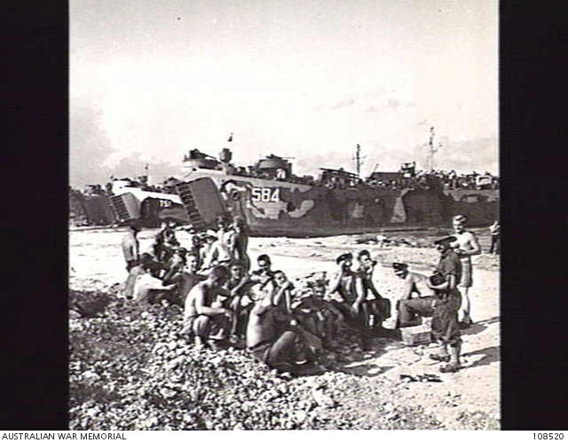 MOROTAI, 1945-05-30. LANDING SHIP TANKS DRAWN UP ON THE BEACH WAITING ...