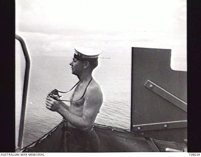 AT SEA, 1945-05-20. ABLE SEAMAN MERRITT, LOOKOUT, CAREFULLY SCANNING ...