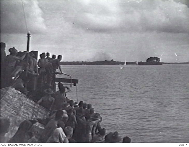 LABUAN, NORTH BORNEO, 1945-06-10. SHELLS AND BOMBS BURSTING ON BROWN ...