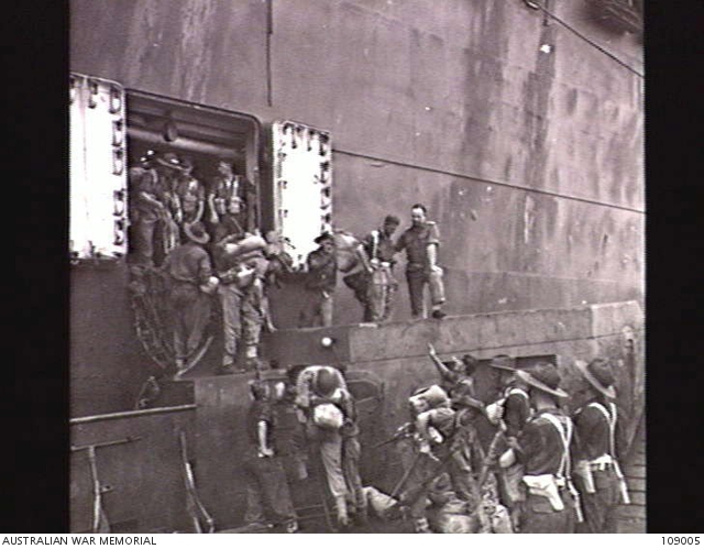 MOROTAI, 9 JUNE 1945. MEMBERS OF 2/4 FIELD REGIMENT DISEMBARKING FROM ...