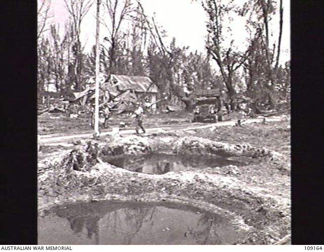 LABUAN ISLAND. 11 JUNE 1945. A SECTION OF THE TOWN AREA DEVASTATED BY ...
