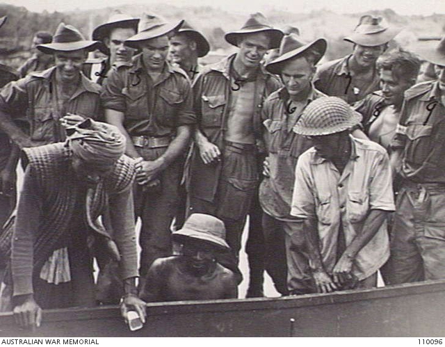 BRUNEI, BORNEO. 24 JUNE 1945. DYAKS AND MEMBERS OF HQ 20 INFANTRY ...