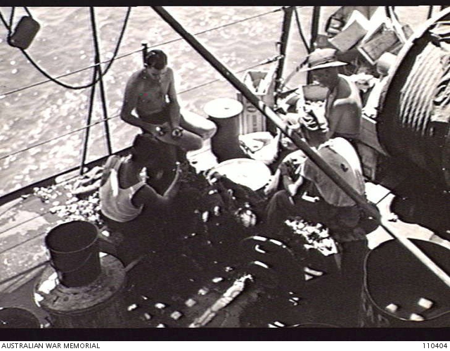 AT SEA. 29 JUNE 1945. COOK PREPARING LUNCH FOR MEMBERS OF 7 DIVISION ...