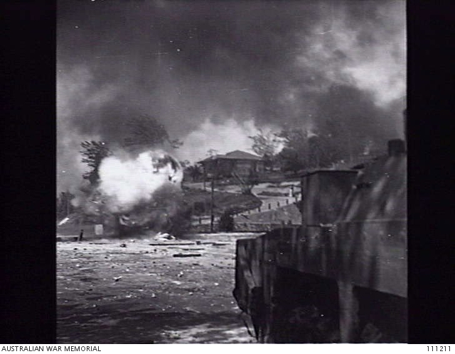 BALIKPAPAN, BORNEO, 1945-07-03. MEMBERS OF 1 ARMOURED REGIMENT BLOWING ...