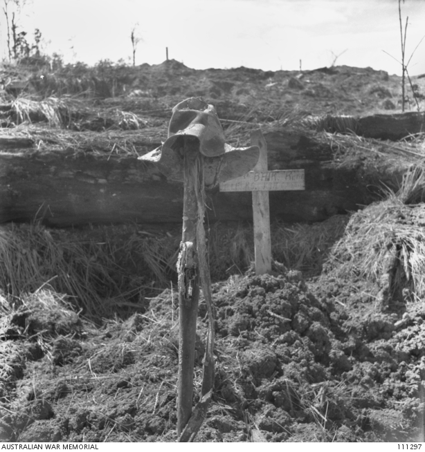 MANGGAR, BORNEO, 10 JULY 1945. THE RIFLE AND MUDDY SLOUCH HAT WHICH ...