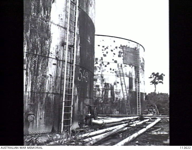 BALIKPAPAN, BORNEO, 1 AUGUST 1945. BULLET RIDDLED PETROL STORAGE TANKS ...