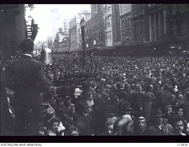 MELBOURNE, VIC. 15 AUGUST 1945. CROWDS OF PEOPLE GATHERING OUTSIDE THE ...