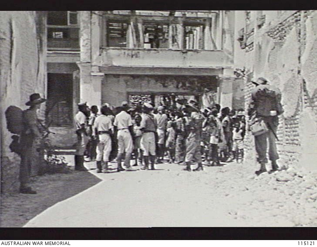 KOEPANG, TIMOR ISLAND. 1945-09-11. A STREET SCENE SOON AFTER THE ...