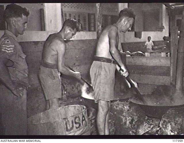 BANGKOK, THAILAND. 1945-09-15. COOKS PREPARING THE EVENING MEAL AT THE ...