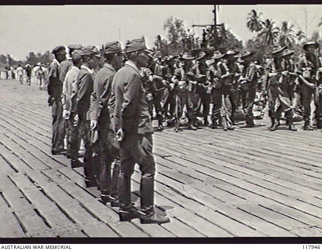 BANJERMASIN, BORNEO. 1945-09-17. JAPANESE ARMY OFFICERS LINED UP AT THE ...