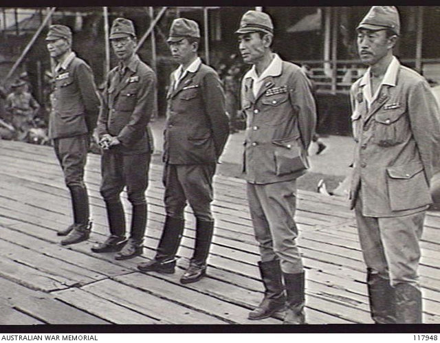 BANJERMASIN, BORNEO. 1945-09-17. JAPANESE ARMY OFFICERS LINED UP AT THE ...