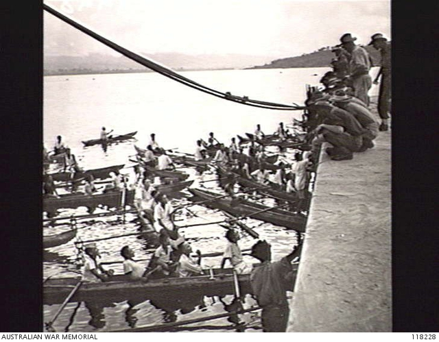 AMBON ISLAND. 1945-09-22. LOCAL NATIVES IN THEIR CANOES CLUSTERED ...