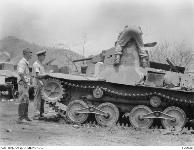 TAIBESSI, PORTUGUESE TIMOR. 1945-09-30. A JAPANESE LIEUTENANT WATCHES ...