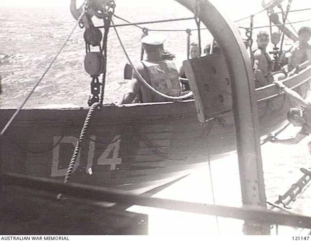 1945-07-08. A LIFEBOAT COMING ABOARD HMAS NEPAL AFTER RESCUING A ...