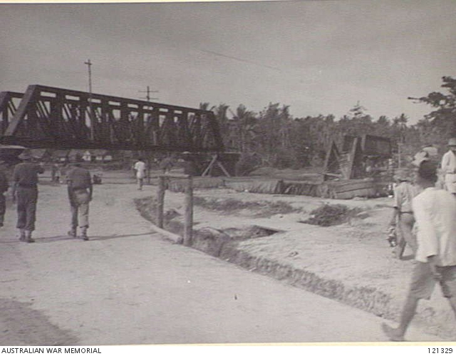 PAPAR, NORTH WEST BORNEO 1945-10-05. THE COLLAPSED RAILWAY BRIDGE OVER ...