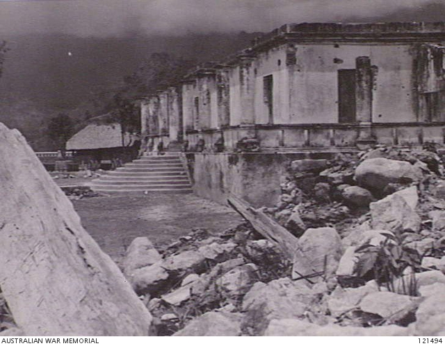 SAME, PORTUGUESE TIMOR 1945-12-16. ONE OF THE POSTO BUILDINGS HEAVILY ...
