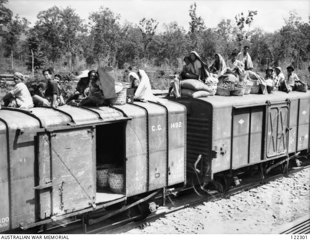Wampo, Thailand. 19 October 1945. Asian natives sitting on the roof of ...